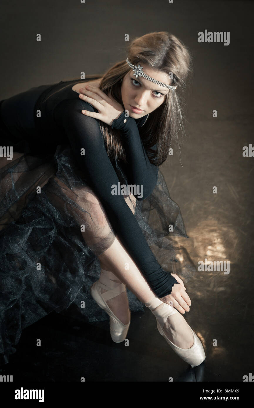 Beautiful female contemporary ballet dancer in black wear posing on a ...