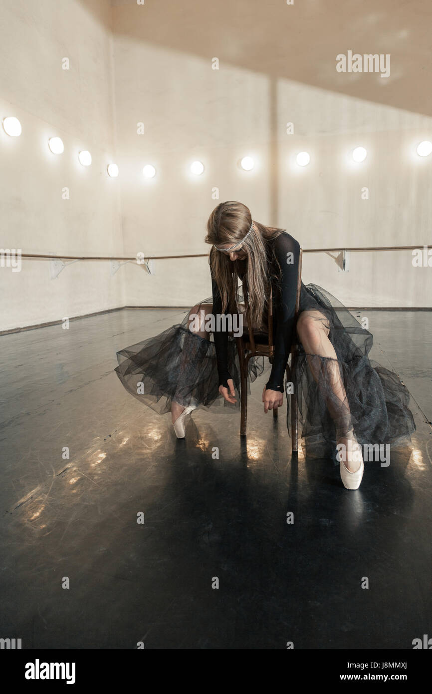 Beautiful female contemporary ballet dancer in black wear posing on a ...
