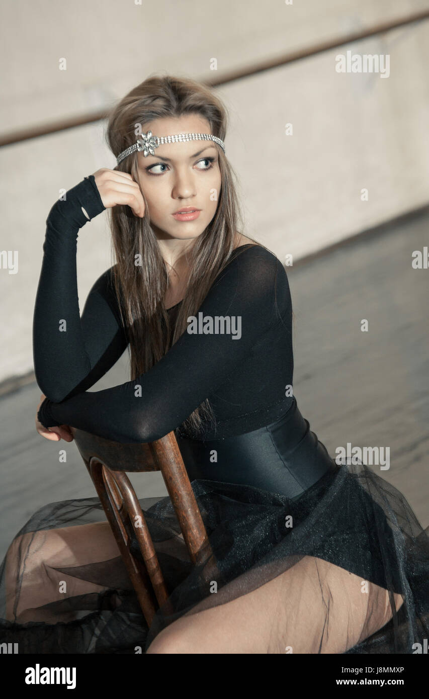 Beautiful female contemporary ballet dancer in black wear posing on a ...