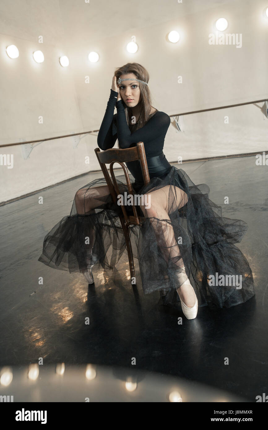 Beautiful female contemporary ballet dancer in black wear posing on a ...