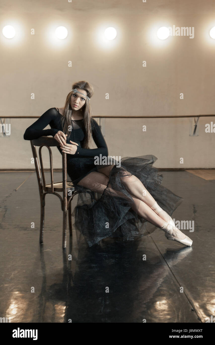 Beautiful female contemporary ballet dancer in black wear posing on a ...