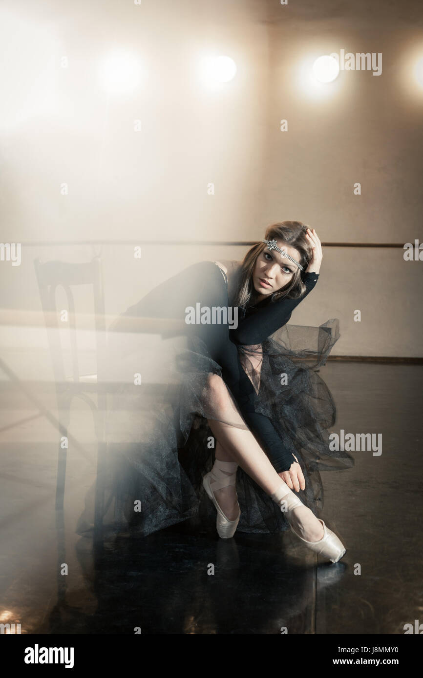 Beautiful female contemporary ballet dancer in black wear posing on a ...