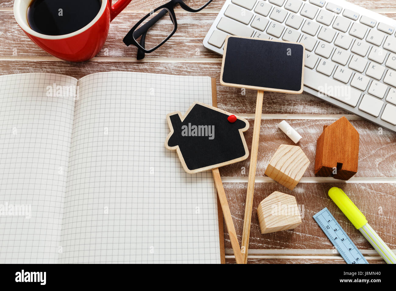 House sale and rent sign with blank notebook and computer keyboard and ...