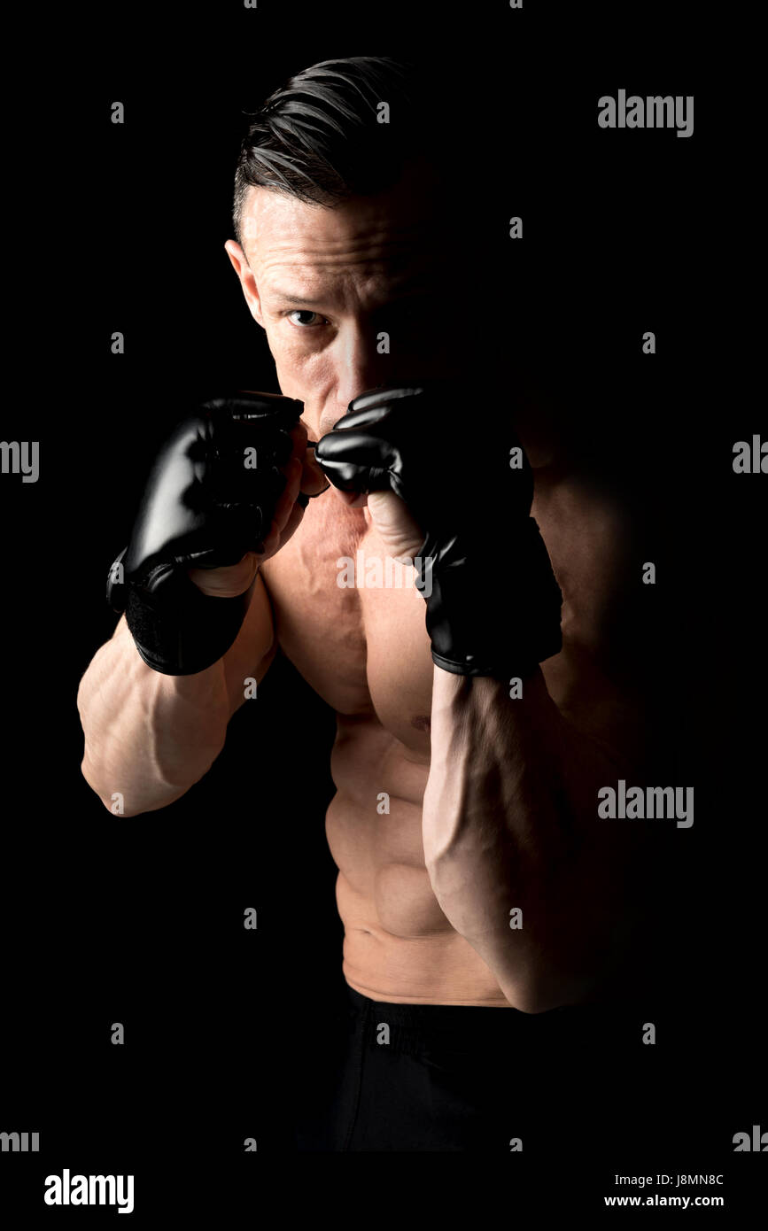 Strong Mixed Martial Arts fighter isolated in black Stock Photo - Alamy