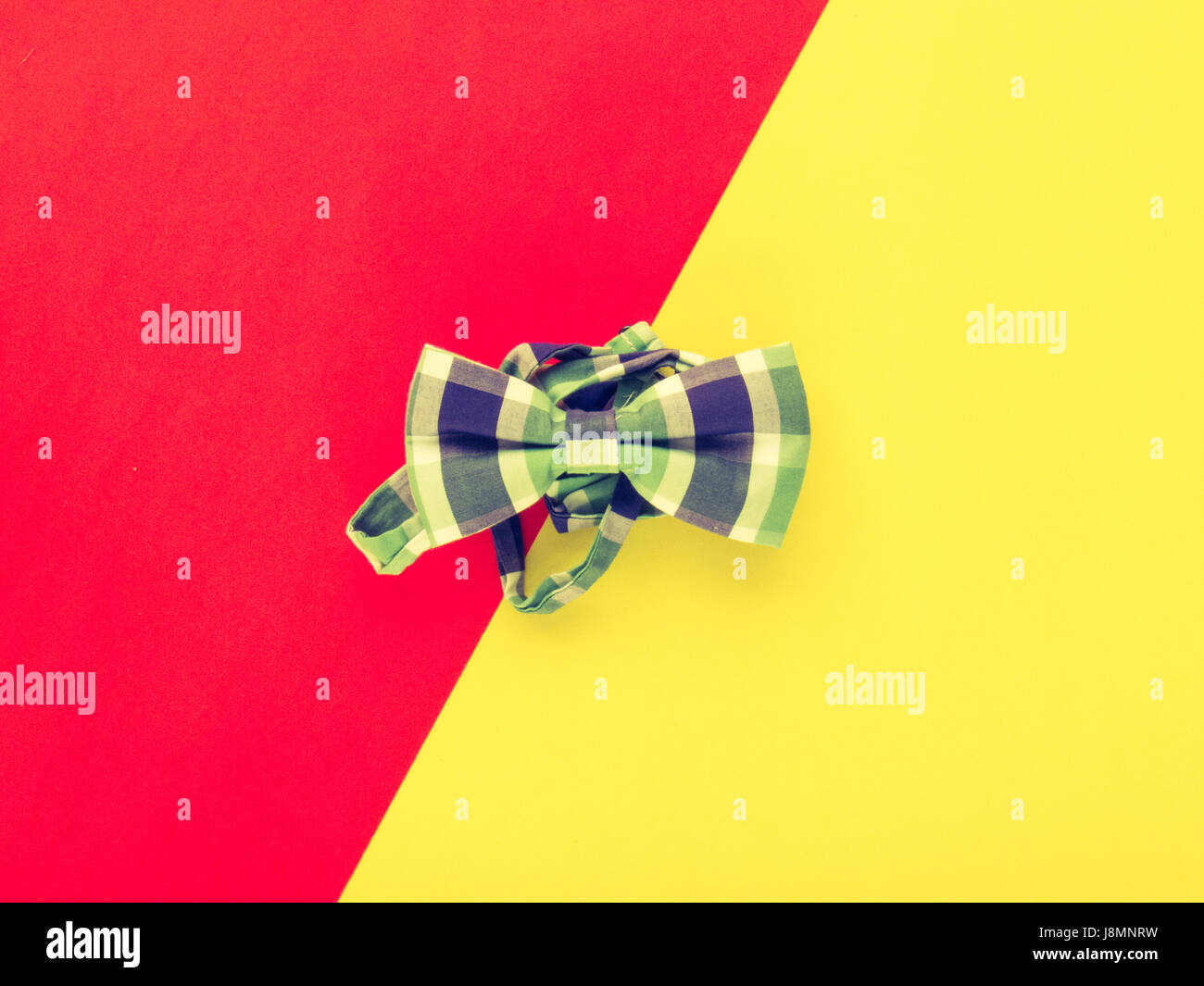 Single green bow tie on a colorful pastel background Stock Photo - Alamy