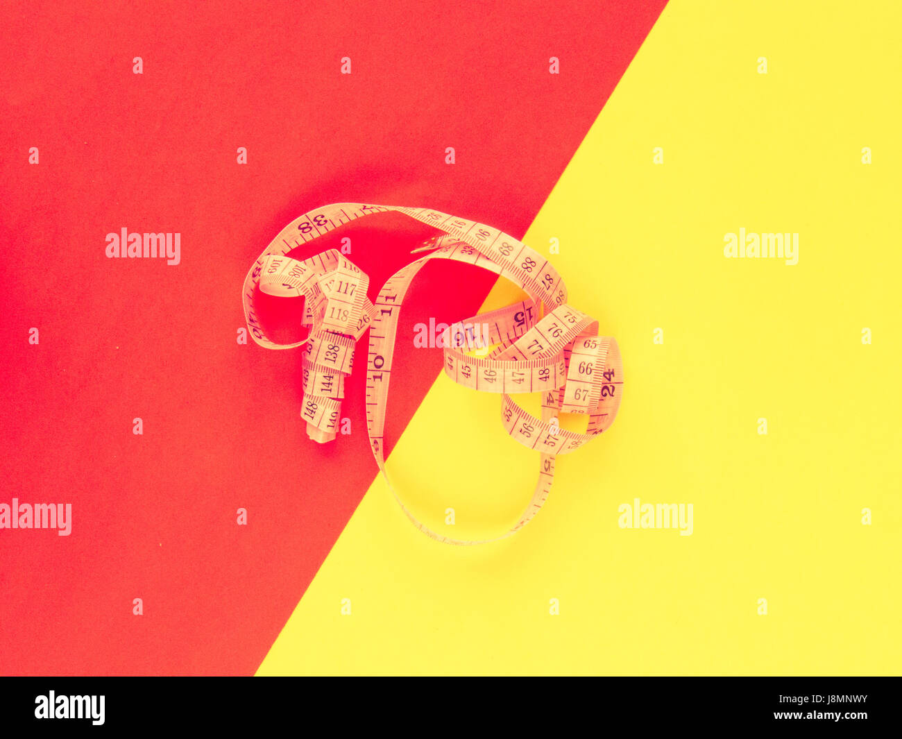 Pink tailor's measure tape on a colorful pastel background Stock Photo ...