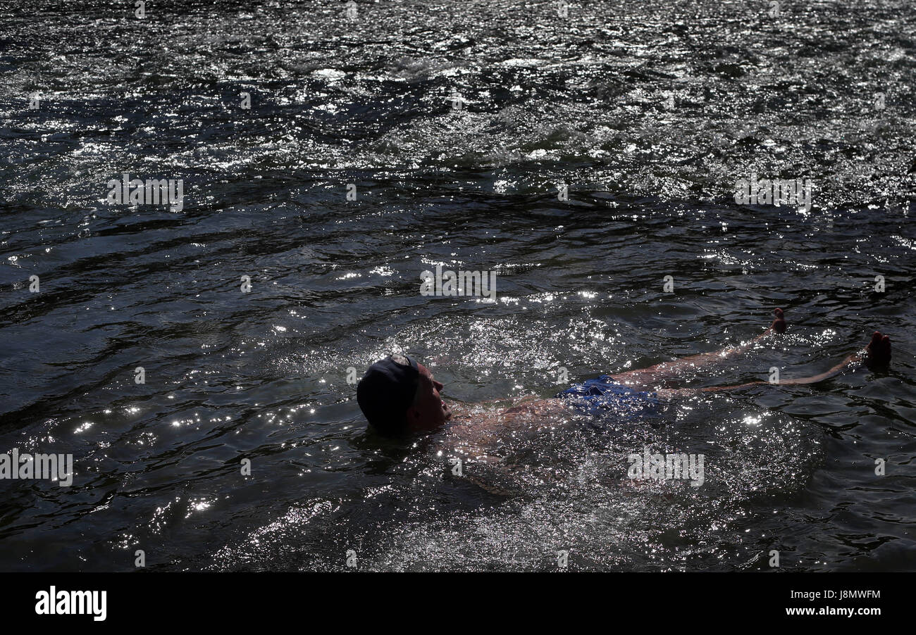 A man can be seen in the cooling waters of the river Lech in Landsberg ...