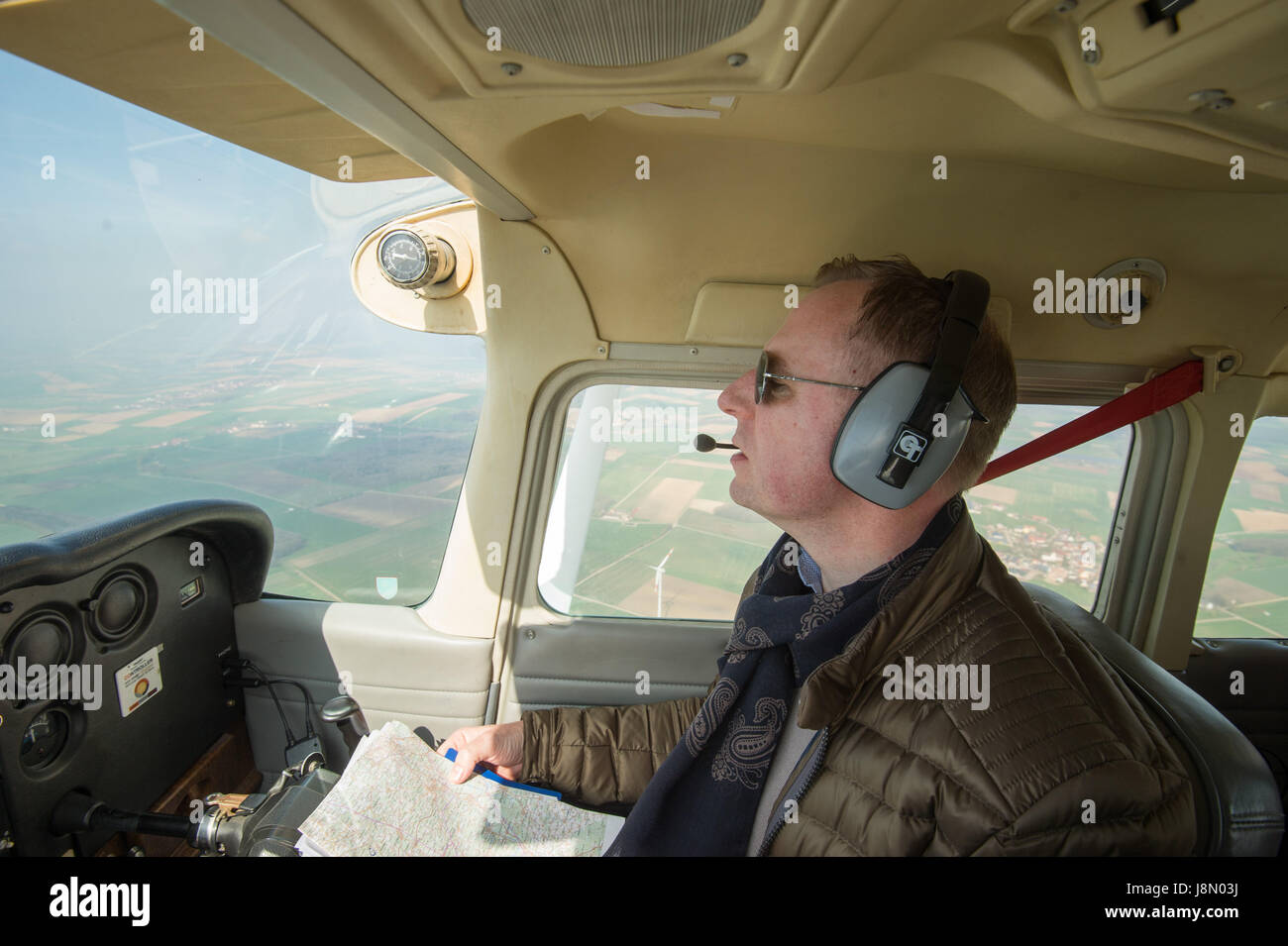 Aerial observer Michael Muenchow looks at the scenery in a Cessna 172 ...