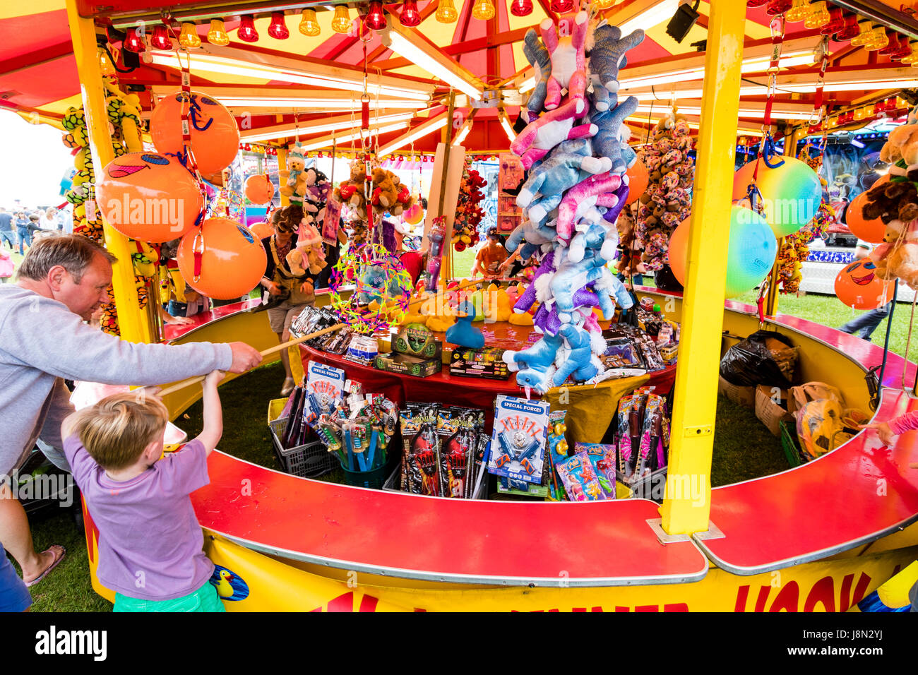 Traditional stall at British funfair ground. 'Catch a duck' stall with ...