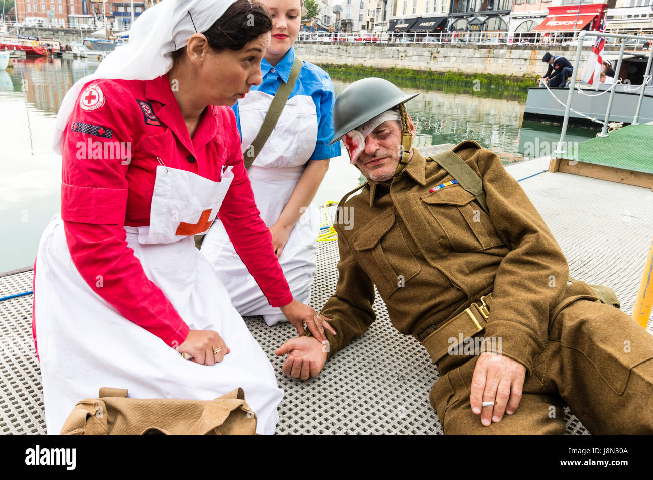 Dunkirk re-enactment at Ramsgate harbour, England. Red Cross nurse ...