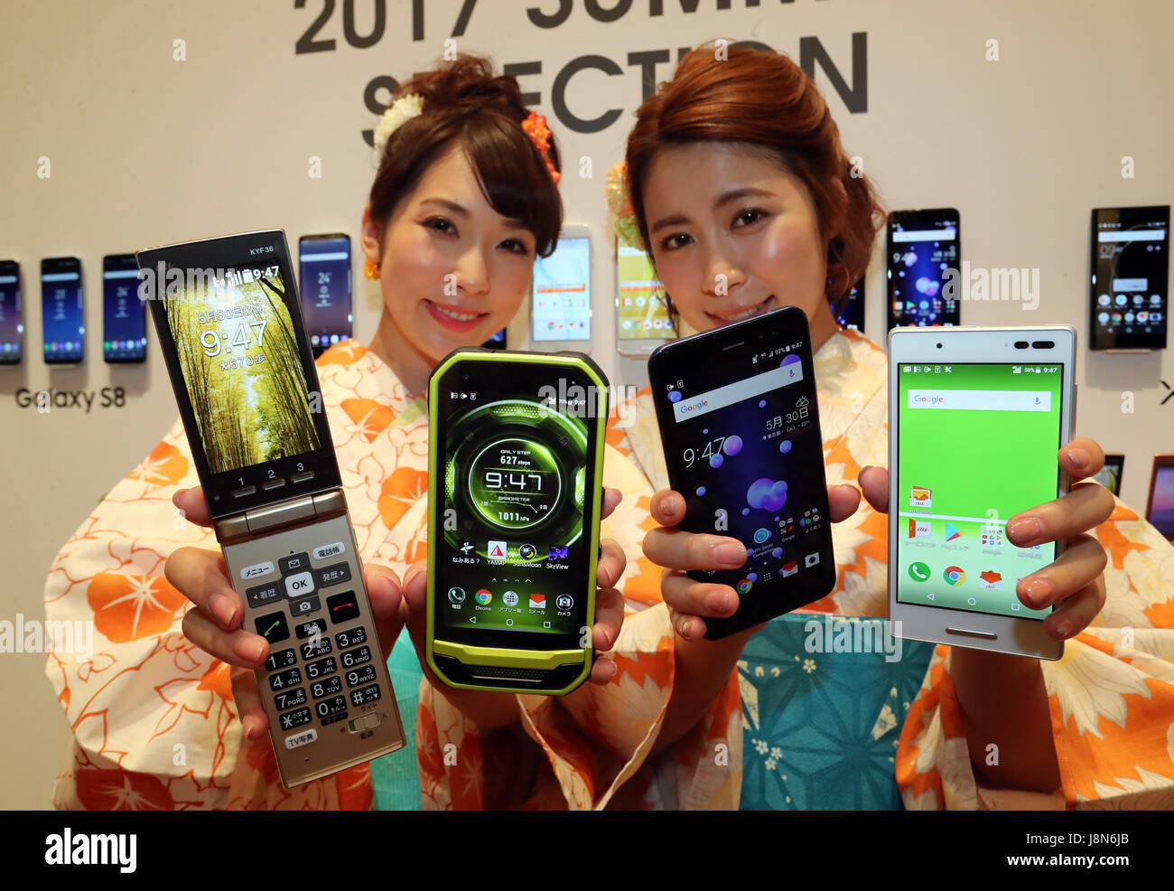 Tokyo, Japan. 30th May, 2017. Models display the new handsets of ...