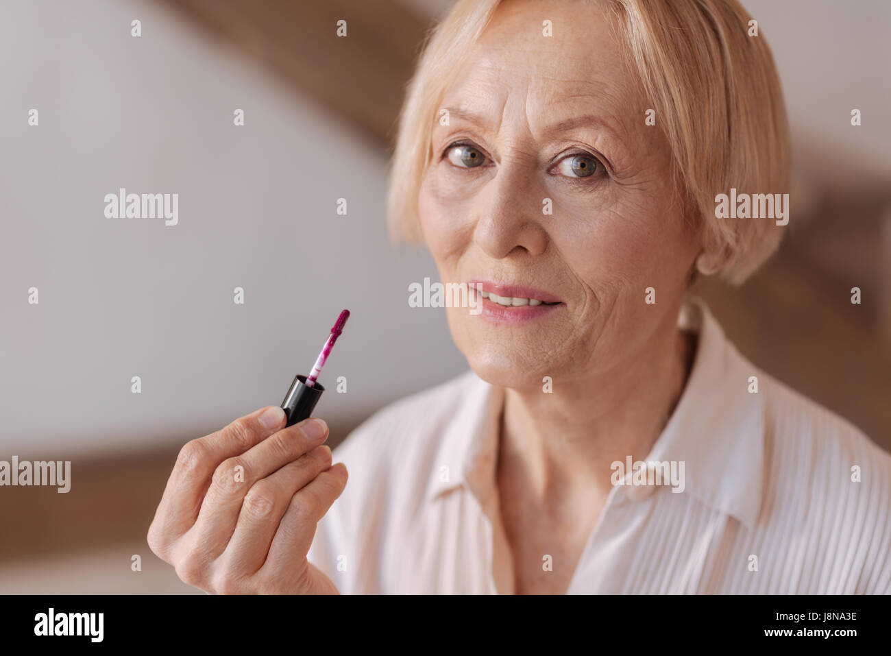Love cosmetics. Beautiful female person wrinkling her forehead and ...