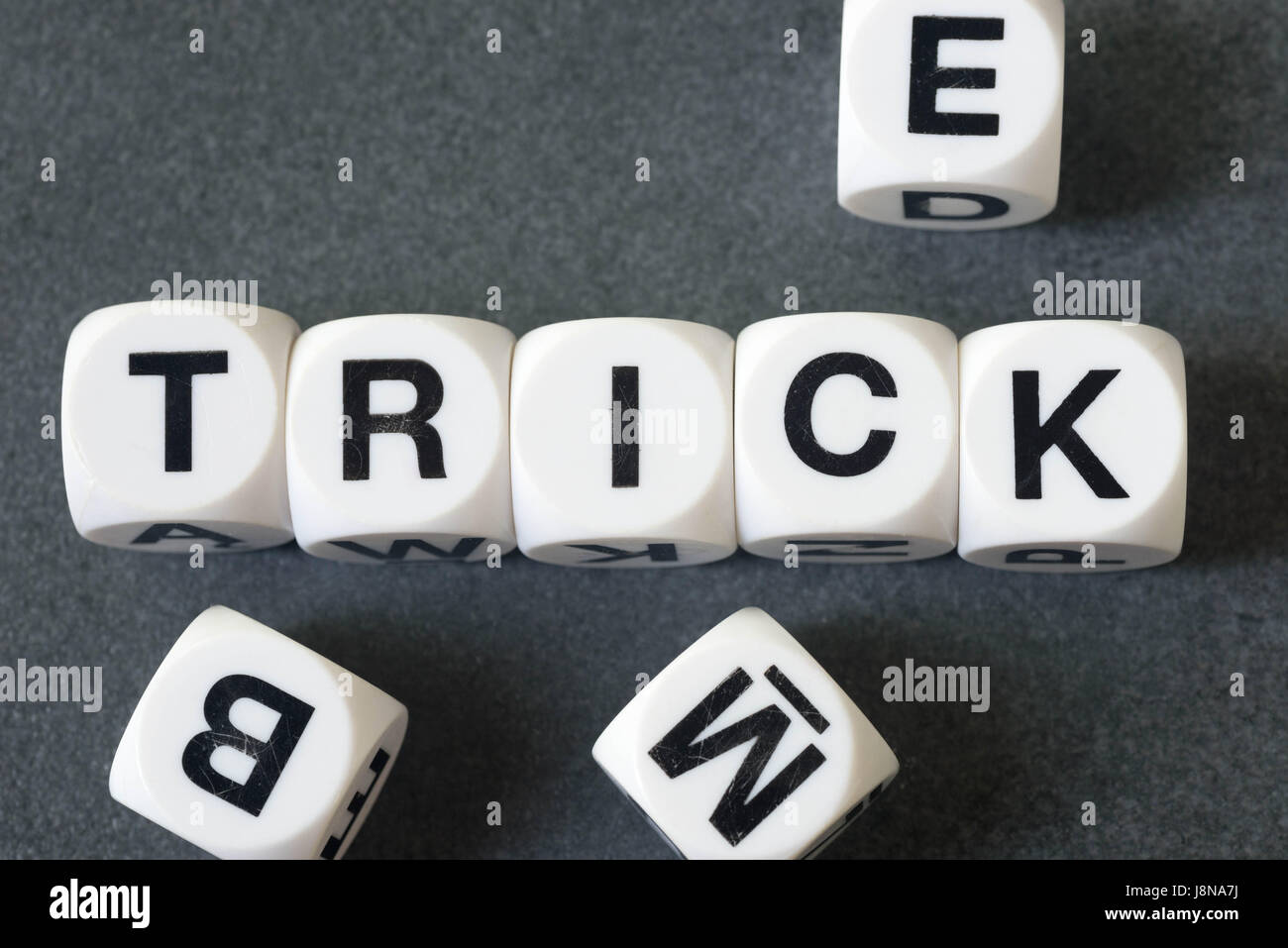 word trick on white toy cubes Stock Photo - Alamy
