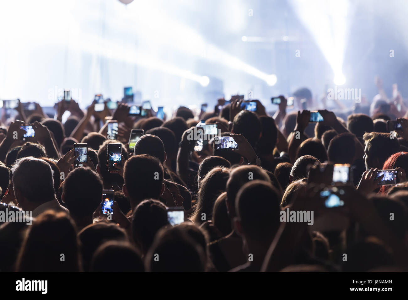 Hand with a smartphone records live music festival, Taking photo of ...
