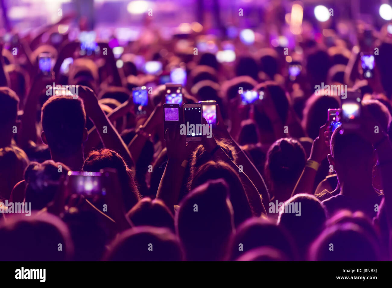 Hand with a smartphone records live music festival, Taking photo of ...