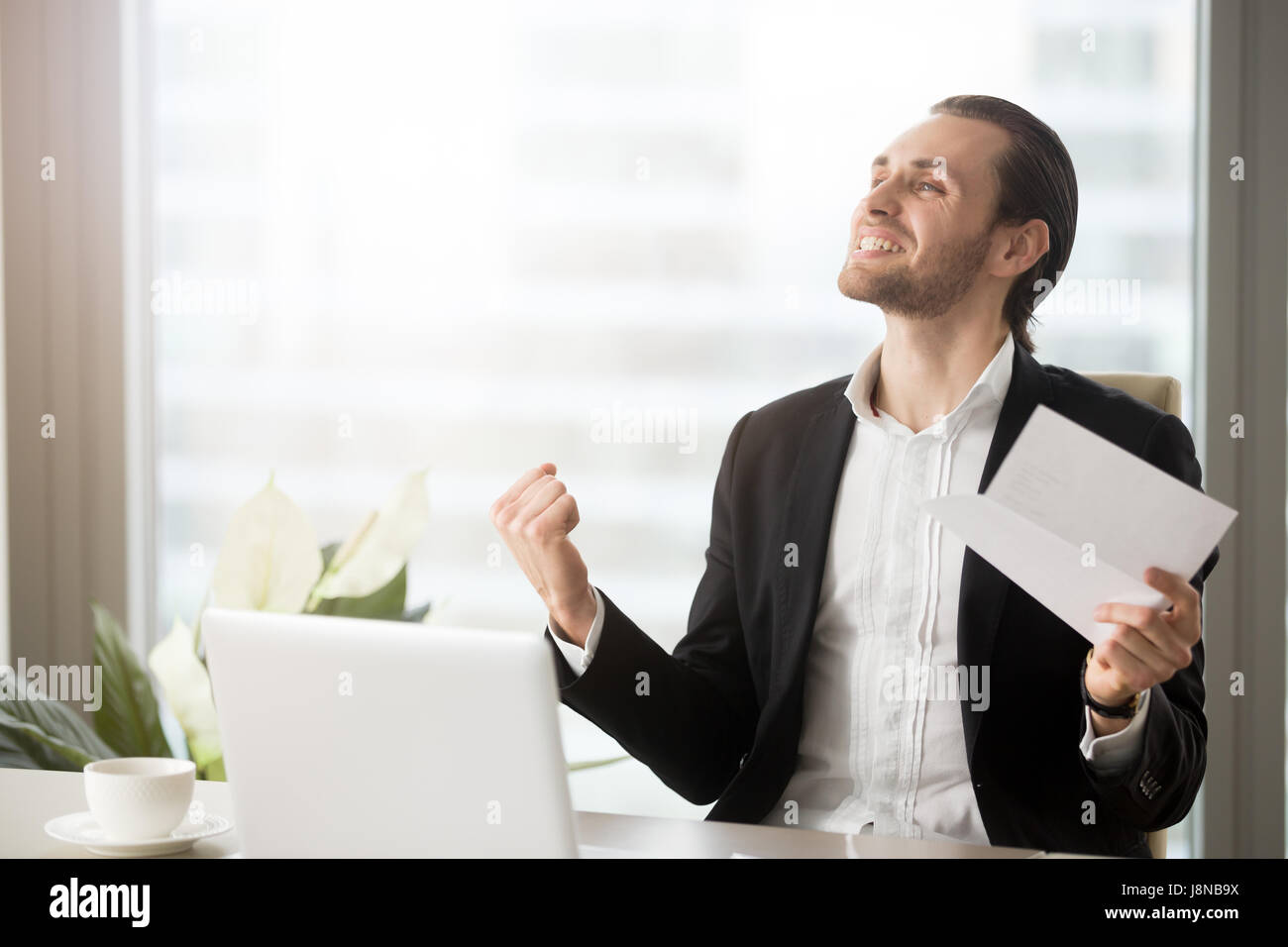 Successful businessman saying yes with document in hand. Happy excited ...
