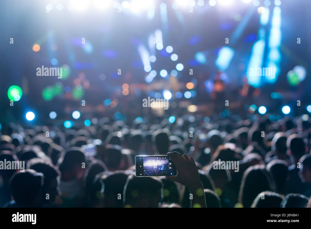 Hand with a smartphone records live music festival, Taking photo of ...