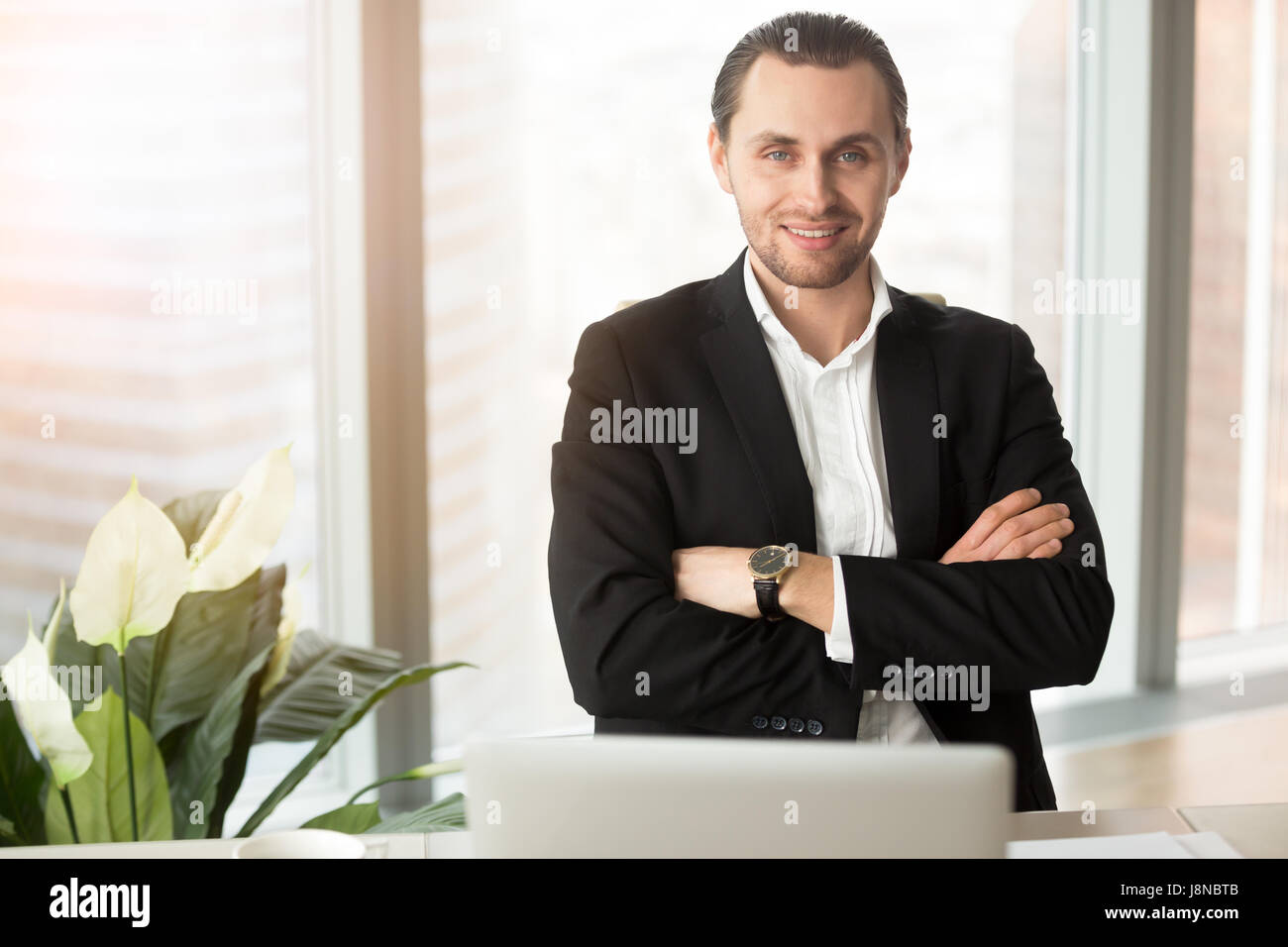 Confident businessman posing at workplace Stock Photo - Alamy