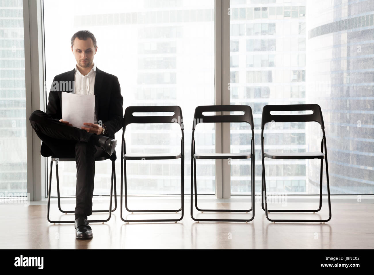 Job applicant reads resume while waiting interview Stock Photo - Alamy