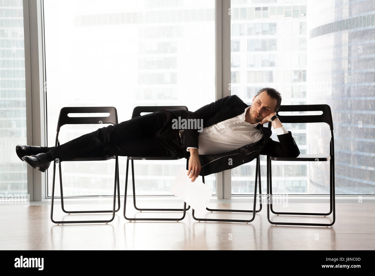 Applicant tired long waiting his turn on interview Stock Photo - Alamy