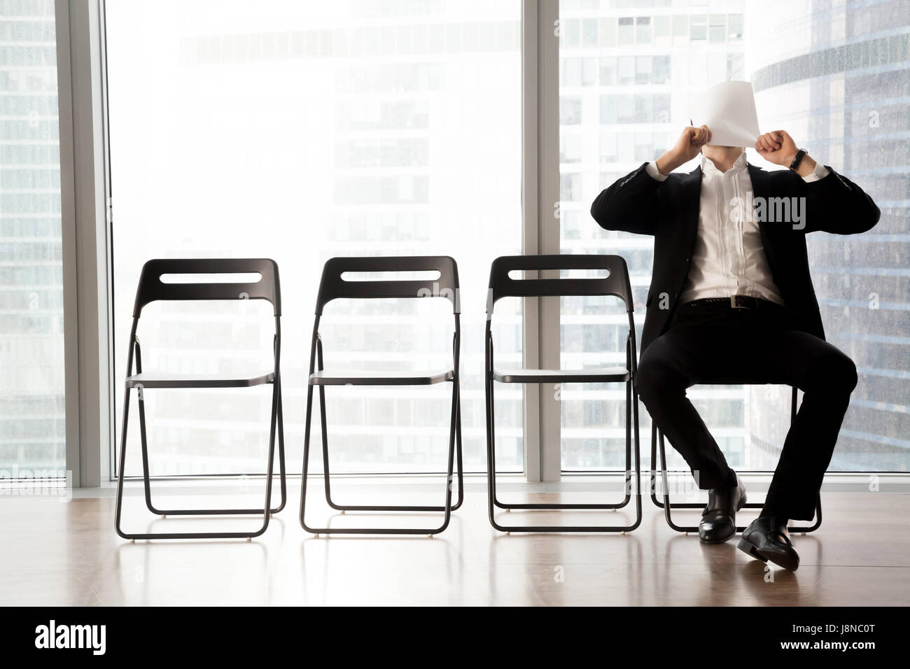 Man languishes while waits for turn on interview Stock Photo - Alamy