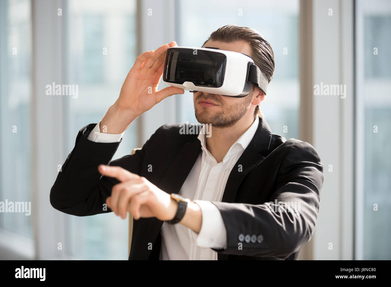 Man wearing vr headset tapping hi-res stock photography and images - Alamy