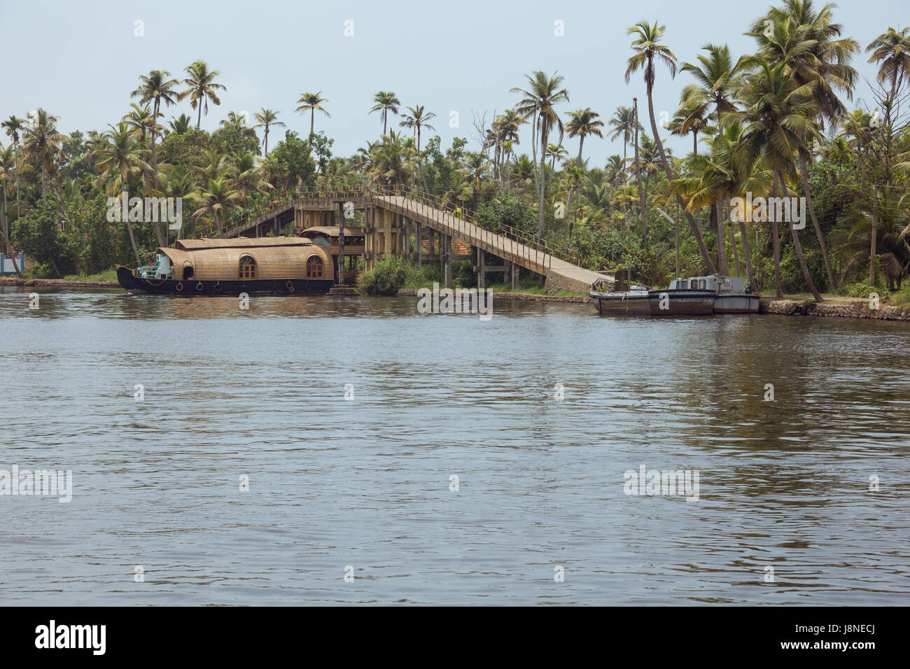 Housboat passing under a bridge over a canal in Alappuzha Stock Photo ...