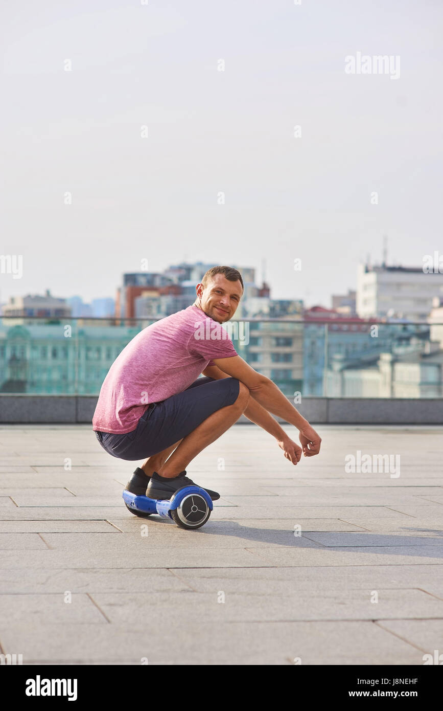 Young man riding hoverboard Stock Photo - Alamy