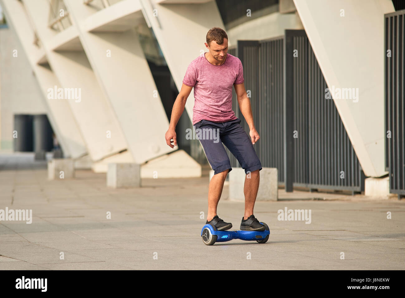 Young man on hoverboard outdoors Stock Photo - Alamy