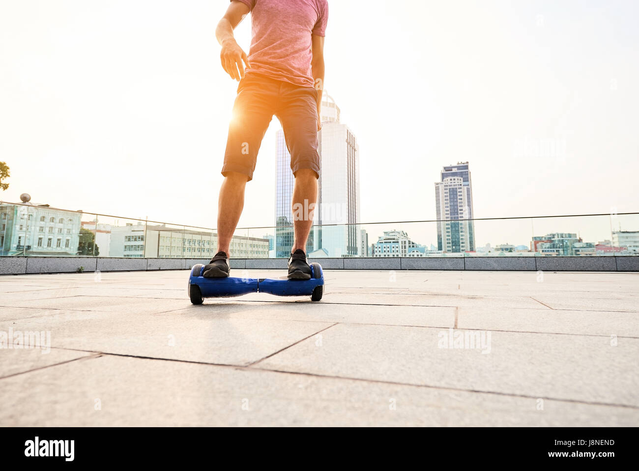 Man riding hoverboard, city Stock Photo - Alamy