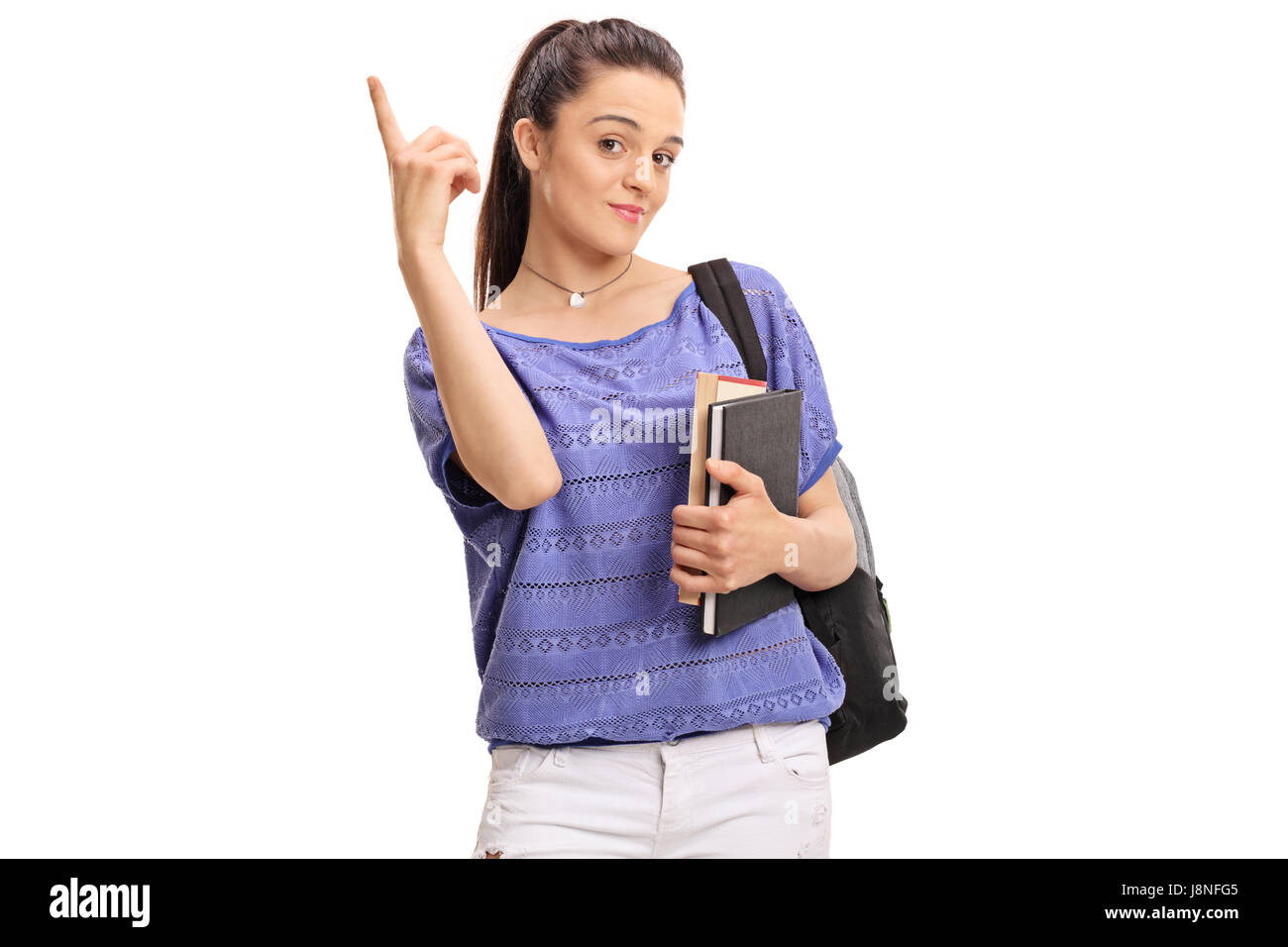 Female teenage student pointing up with her finger isolated on white ...