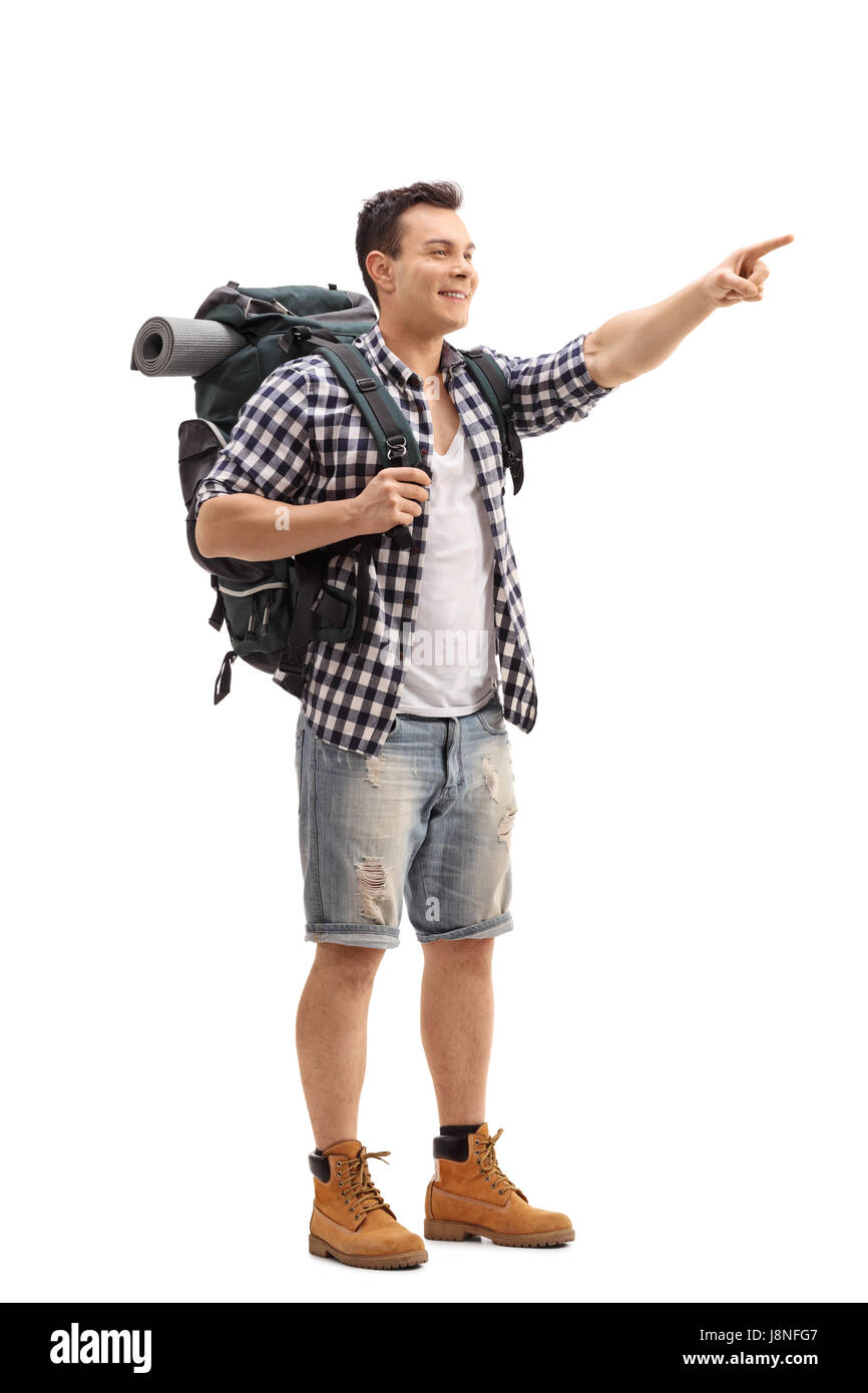 Full length portrait of a hiker pointing with his finger isolated on ...