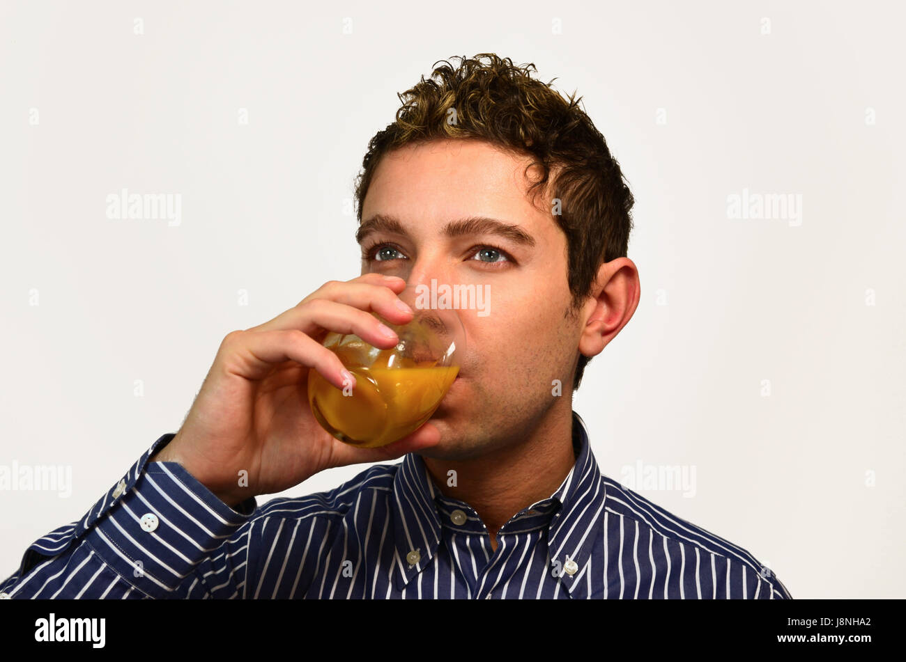 Attractive guy drinking juice smiling hi-res stock photography and images - Alamy
