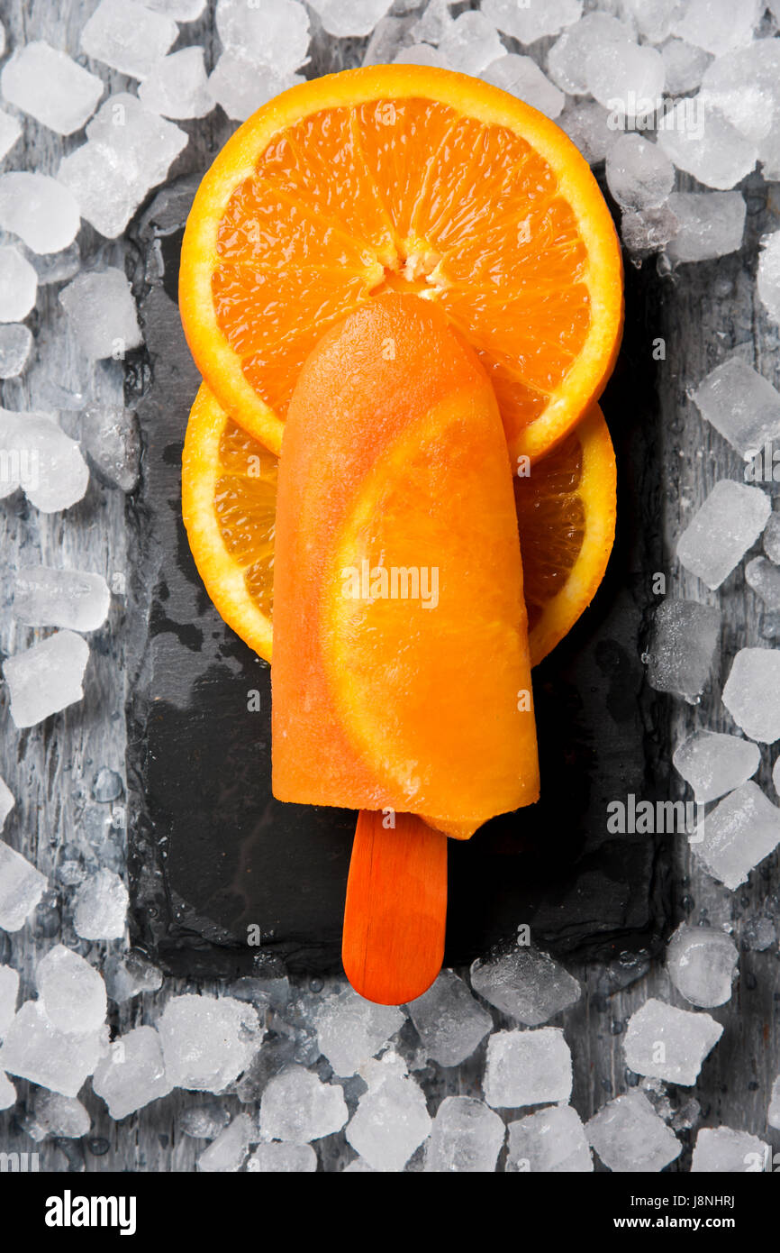 high-angle shot of a homemade ice pop made with natural orange juice ...