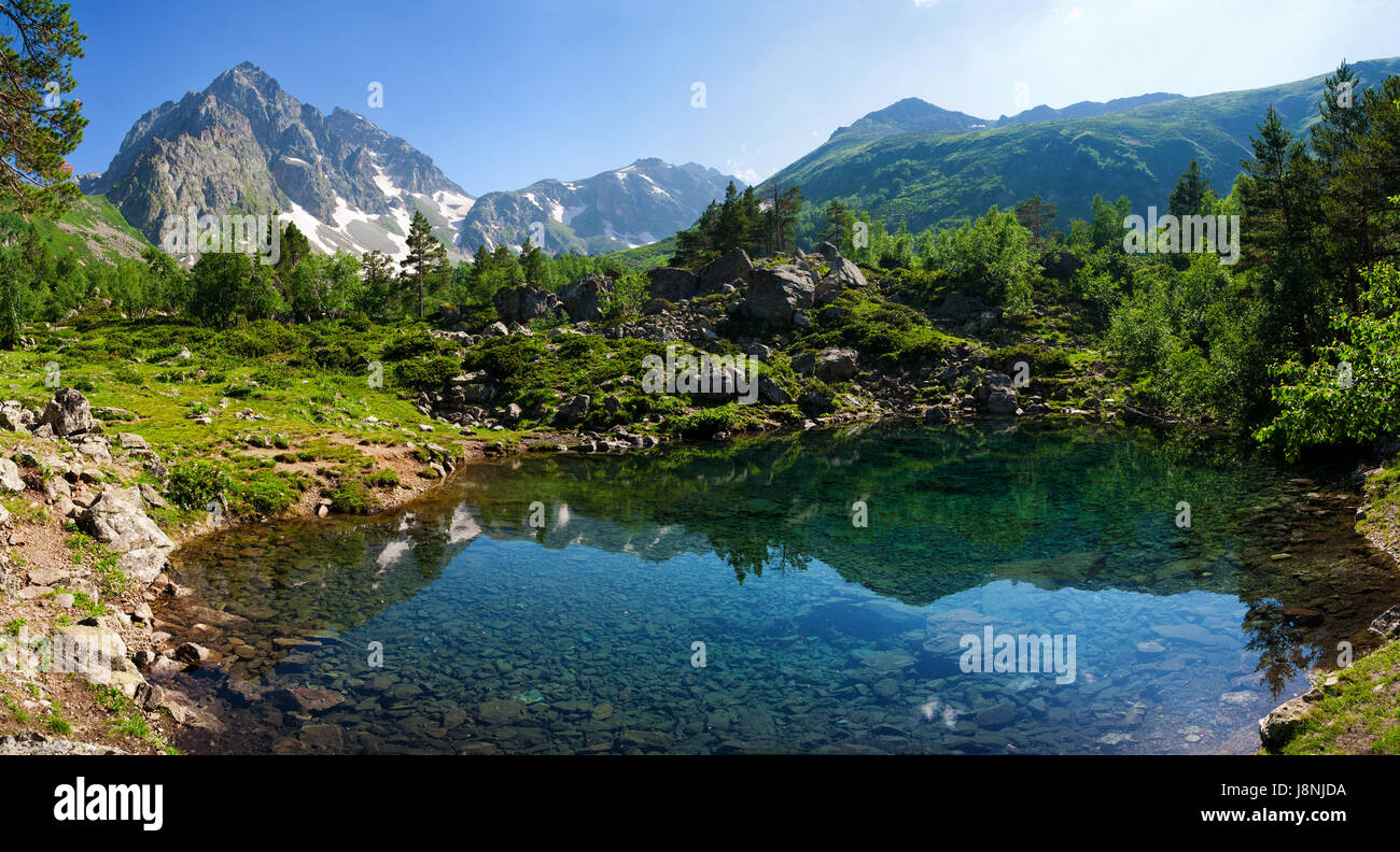 Mountain Lake in the highlands of the Caucasus. The water displays ...