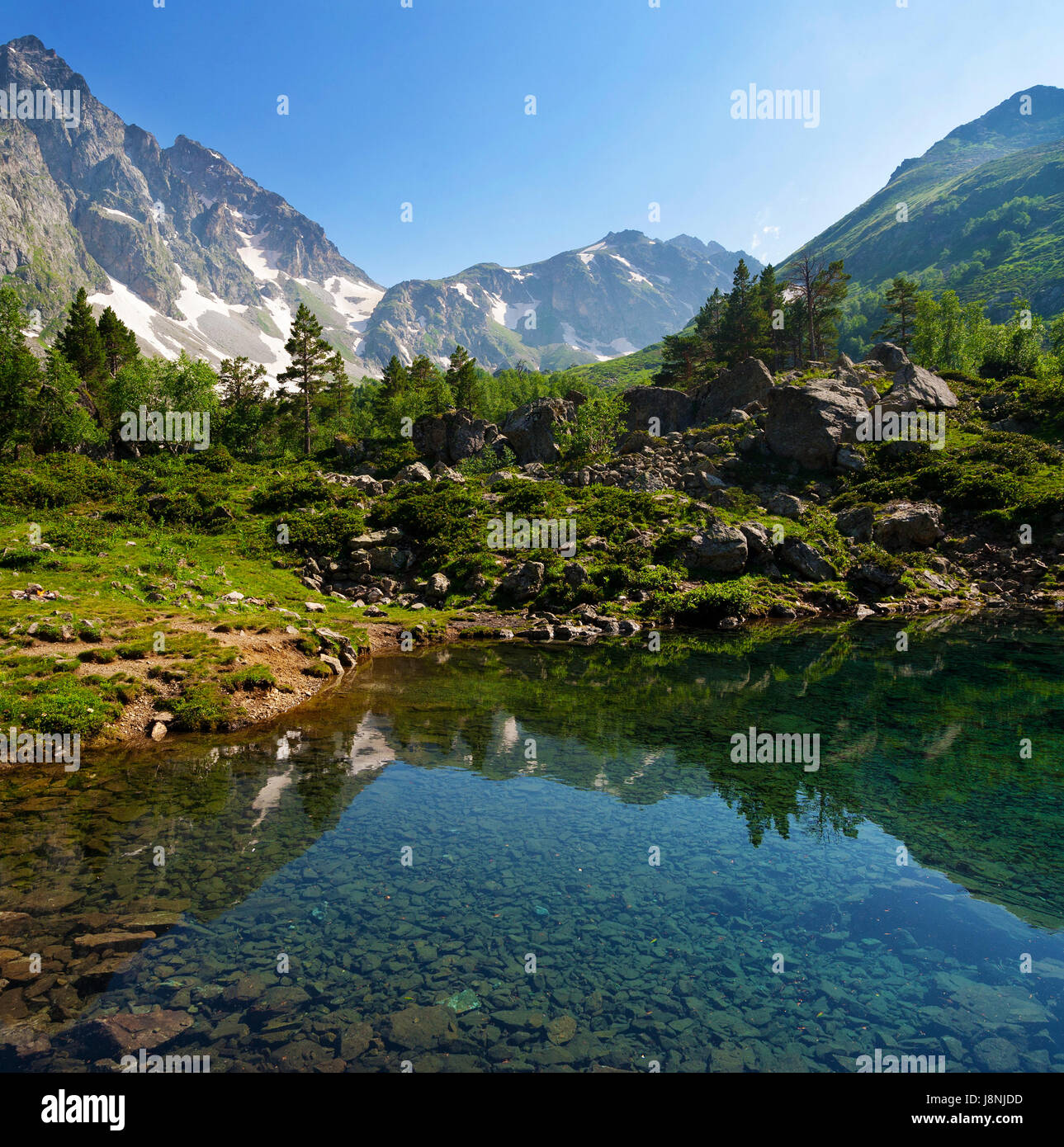 Mountain Lake in the highlands of the Caucasus. The water displays ...