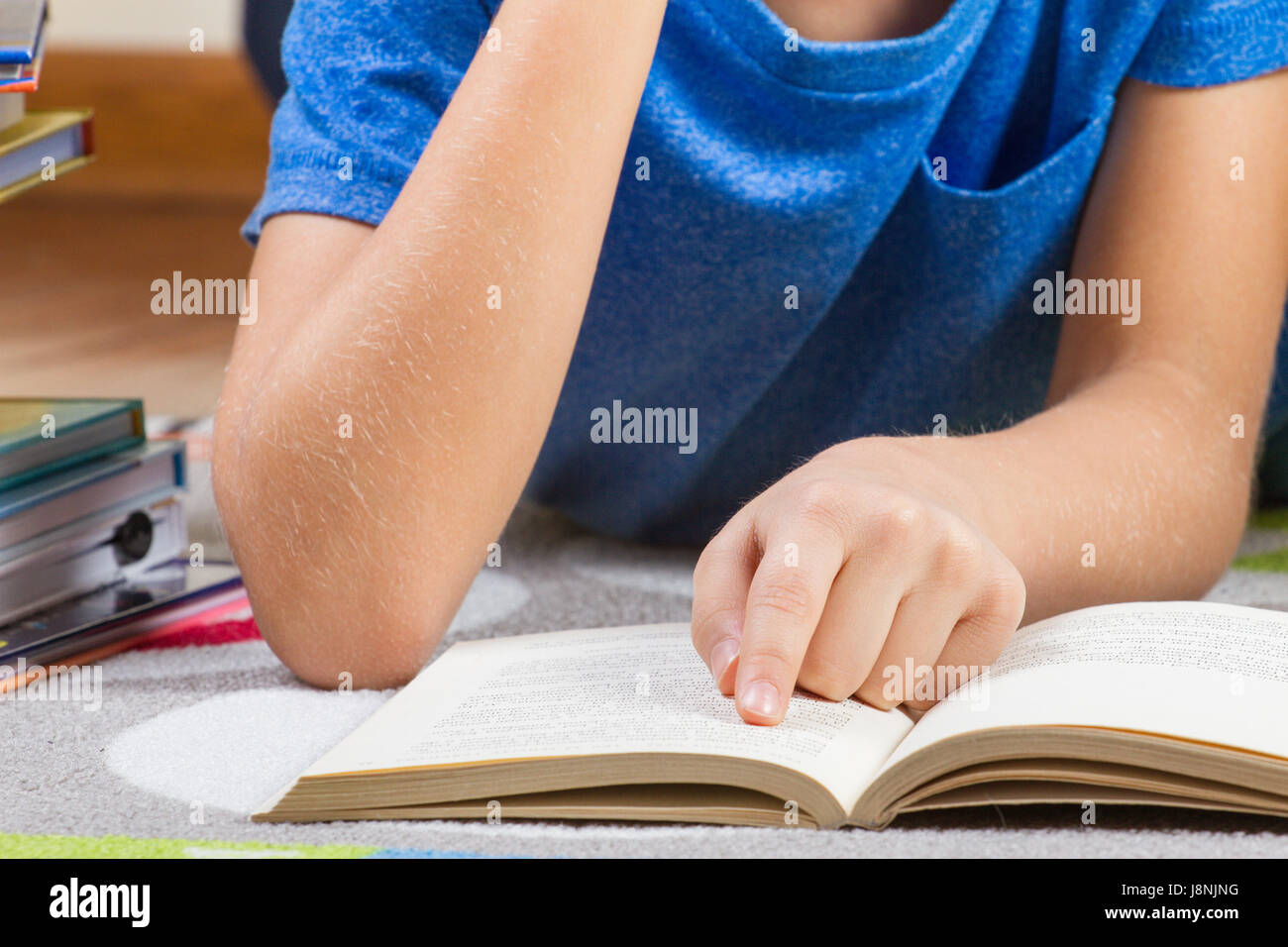 Kid hand on the book while reading books Stock Photo - Alamy