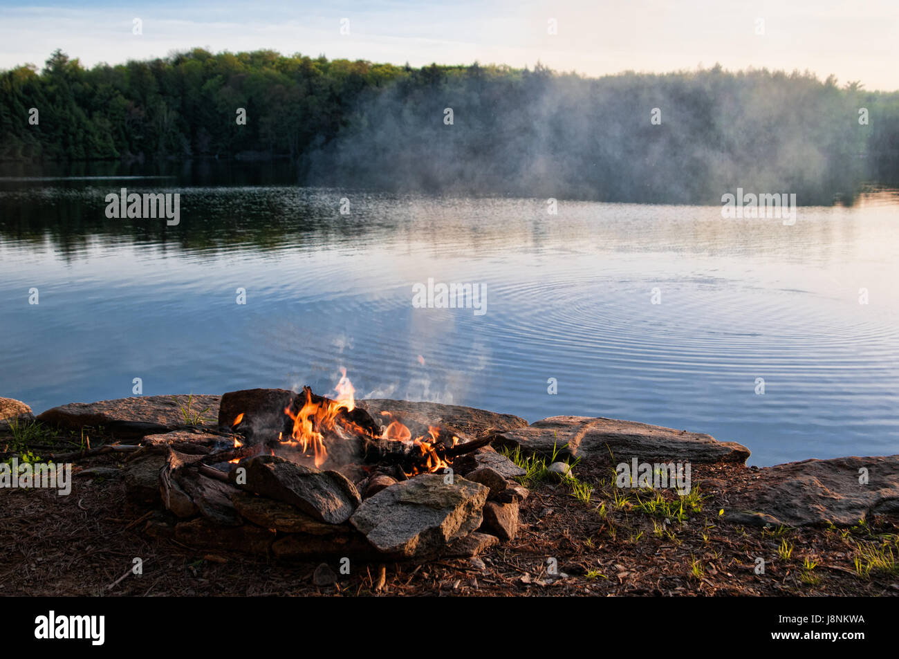 Bonfire by a lake in ontario canada Stock Photo - Alamy