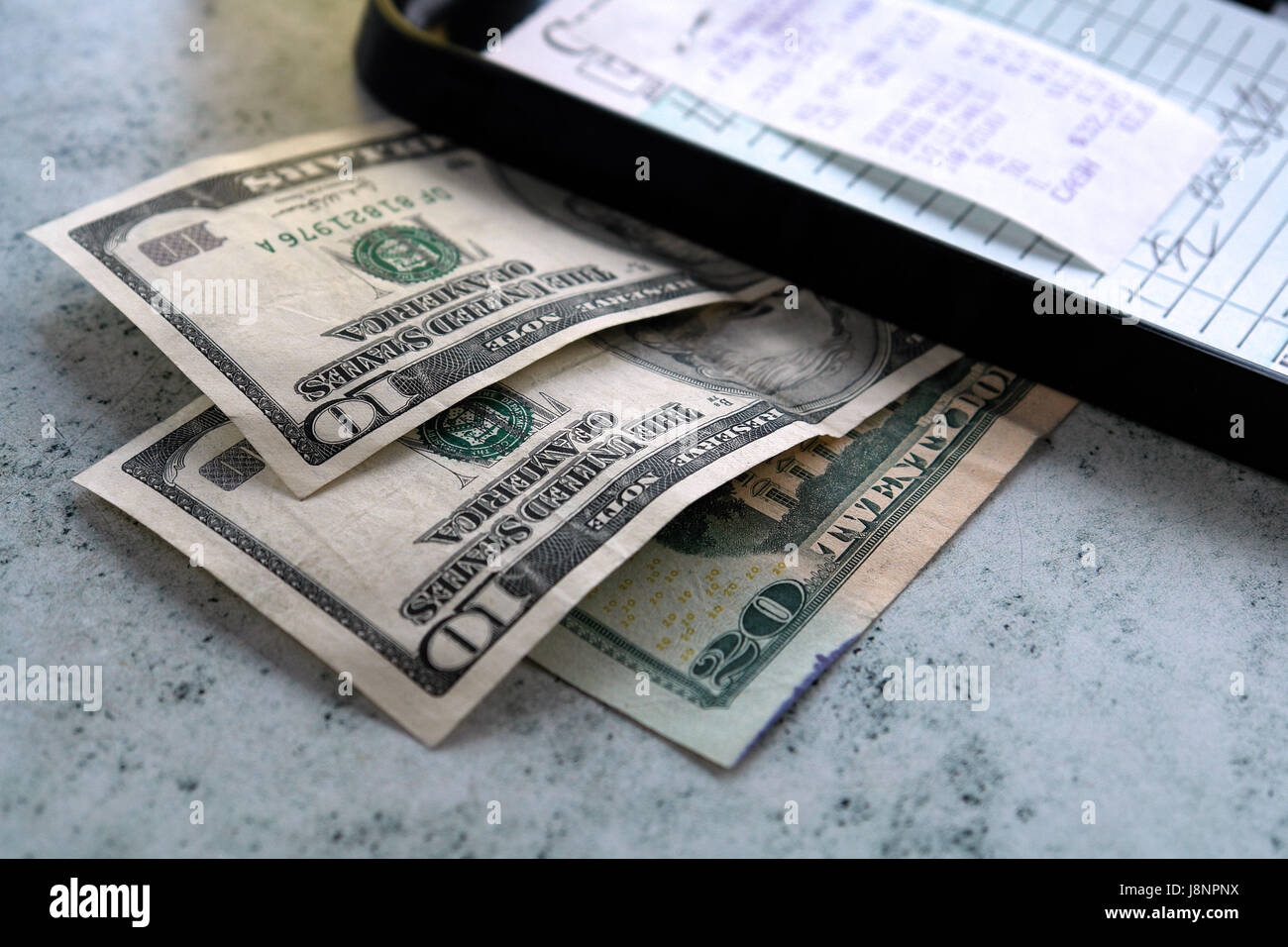 Pays in dollar bills on a bar counter Stock Photo - Alamy