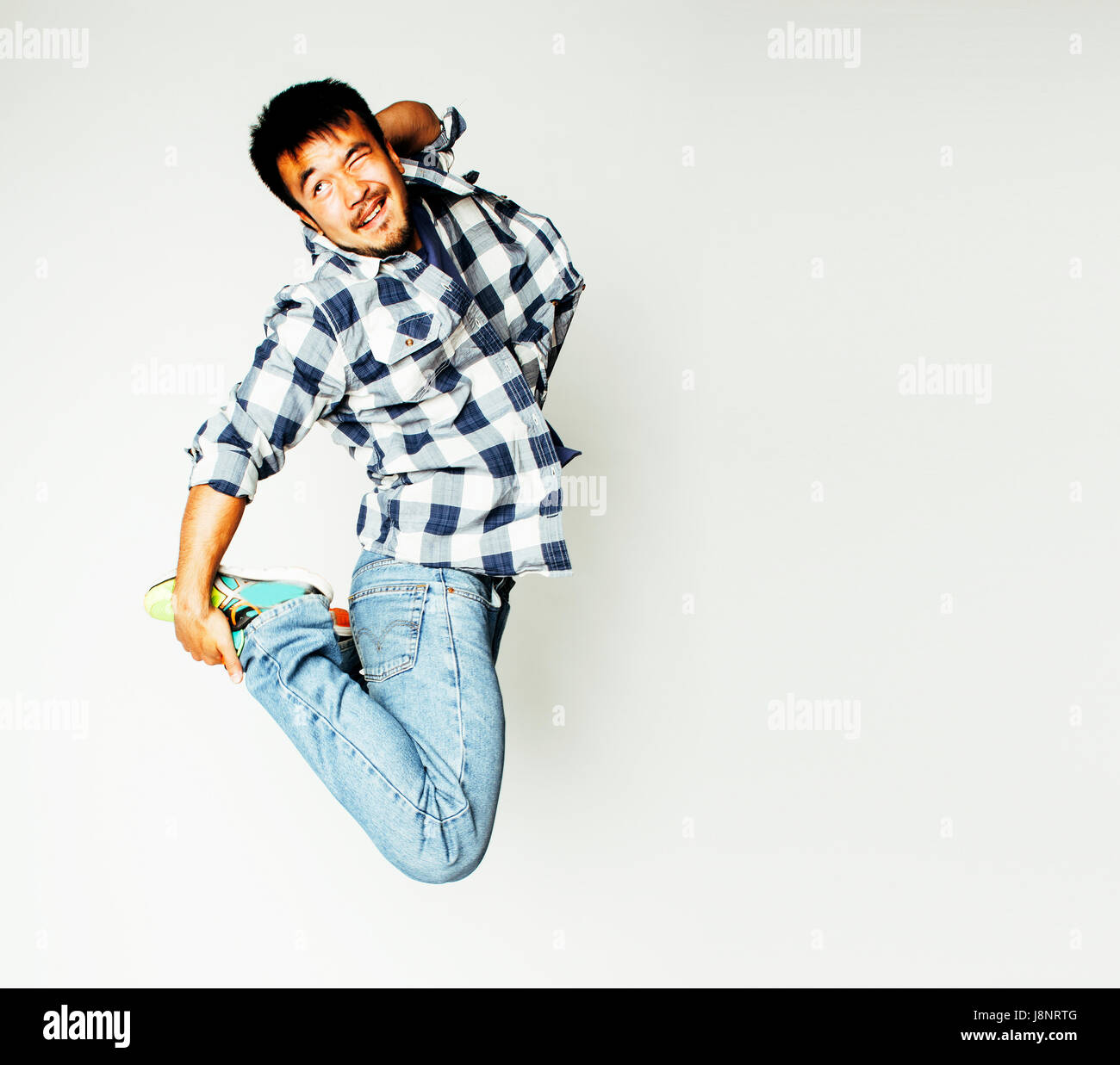 young pretty asian man jumping cheerful against white background Stock ...