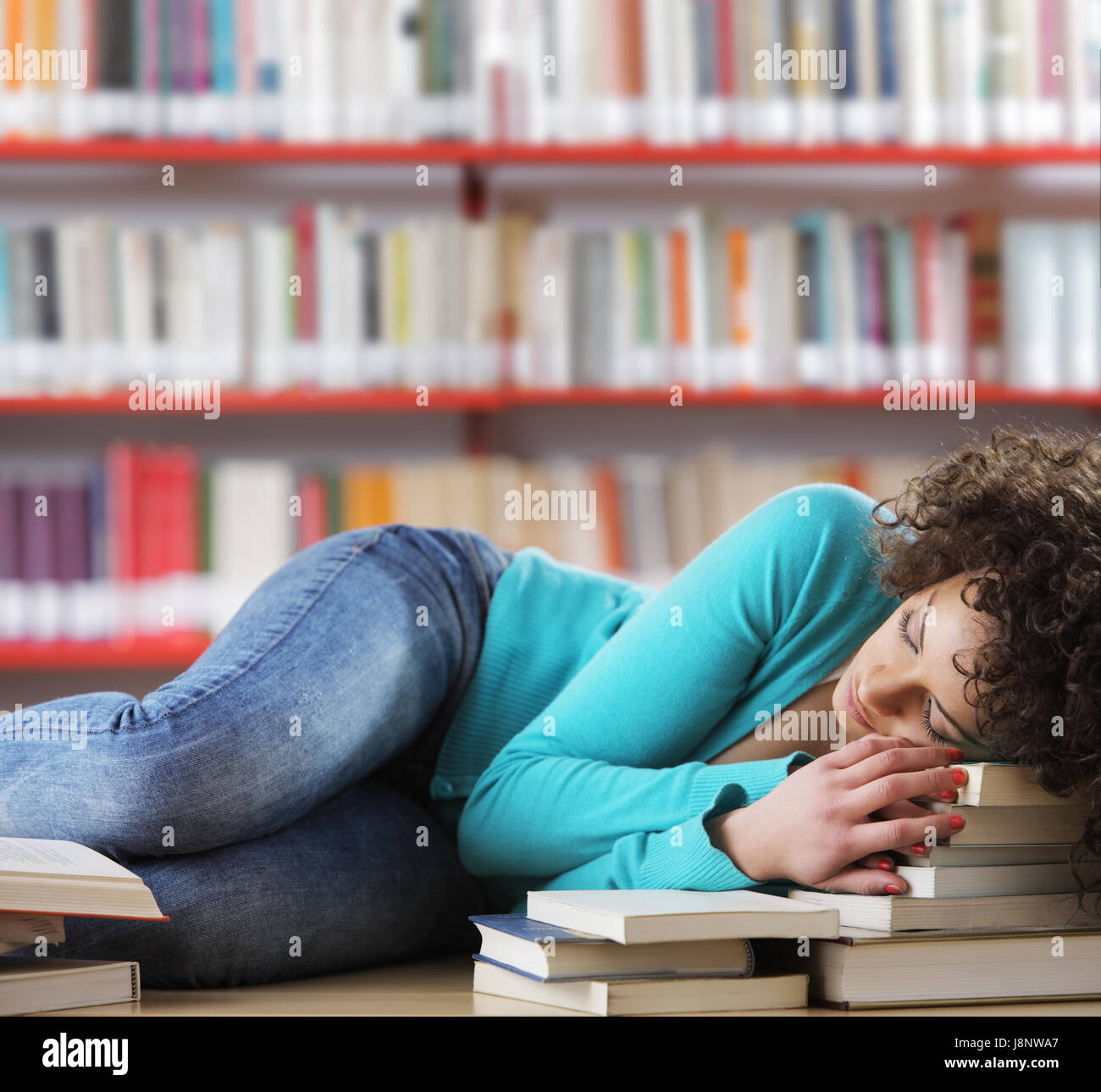 Student sleeping on desk in the library Stock Photo - Alamy