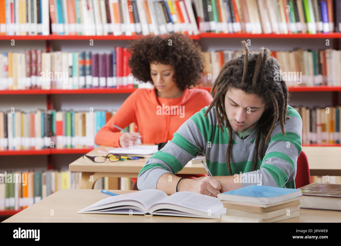 Two students in a library Stock Photo - Alamy