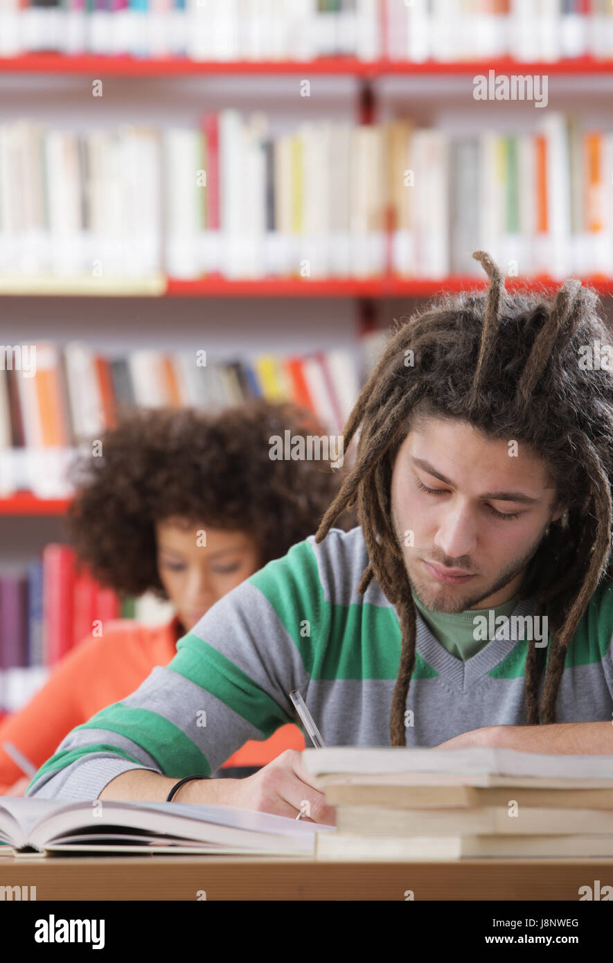 Two students in a library Stock Photo - Alamy