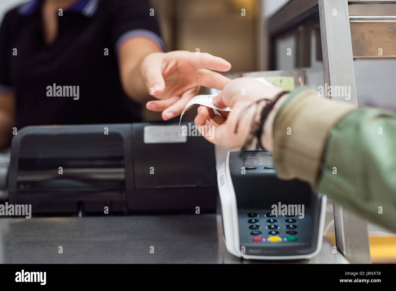 Woman taking receipt checkout counter hi-res stock photography and ...