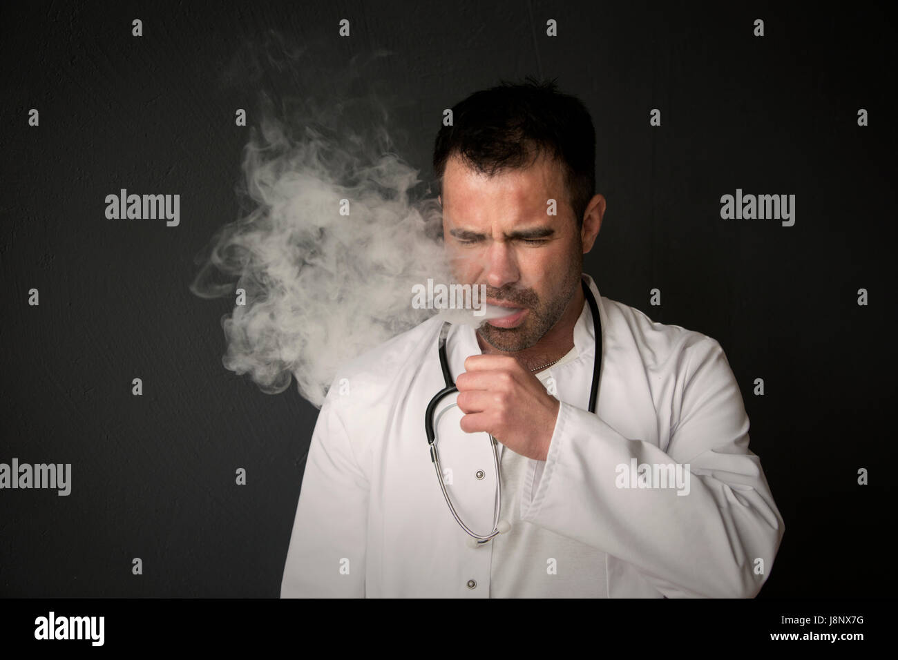 portrait of handsome doctor smoking and coughing Stock Photo - Alamy