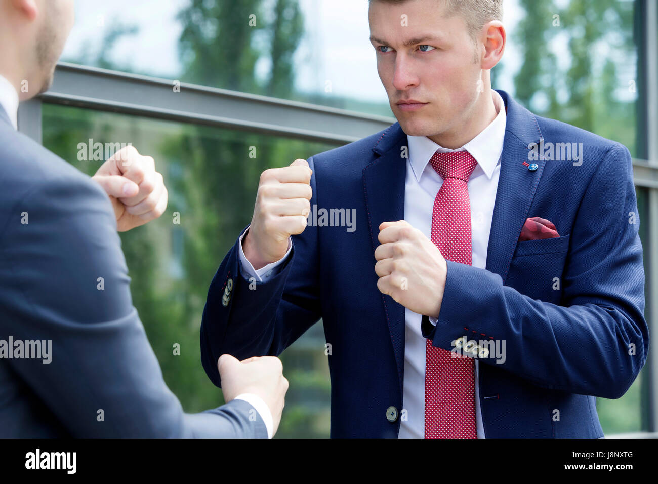 two businessmen standing outside and fighting iwth their fists Stock ...