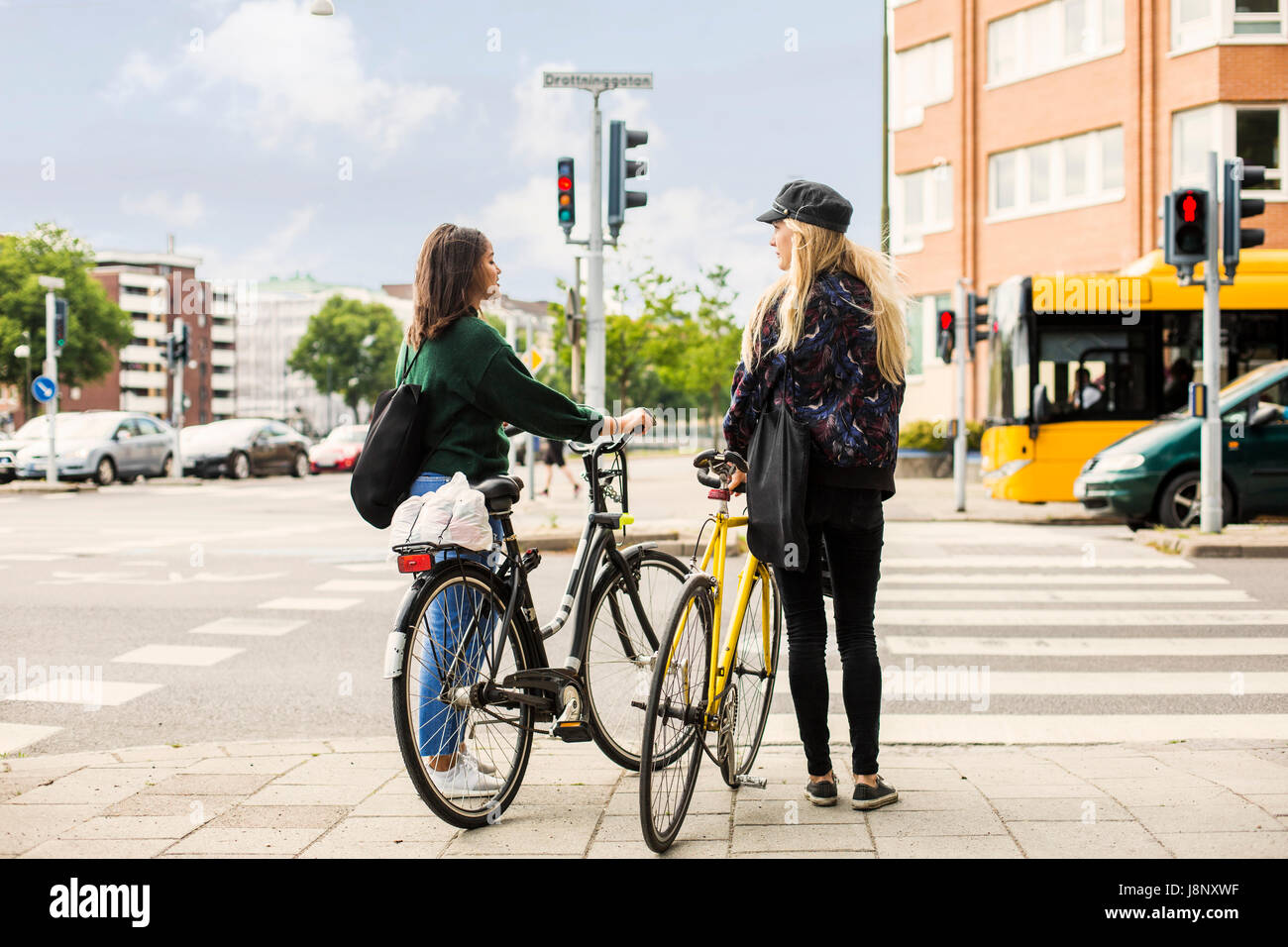 Women pushing bikes hi-res stock photography and images - Alamy