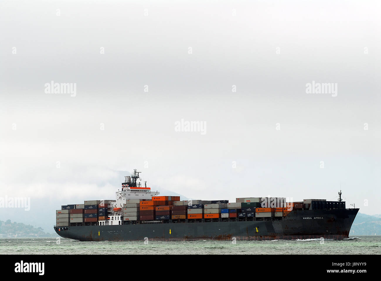 Large cargo ship in water carrying colorful shipping containers ...