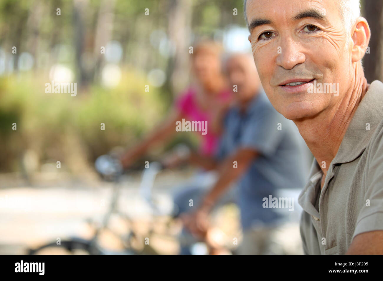 Elderly man riding bicycle bike ride exercise park cycle hi-res stock ...