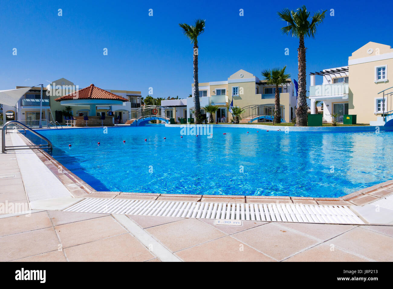 Hotel outdoor swimming pool with clear water and bar Stock Photo - Alamy